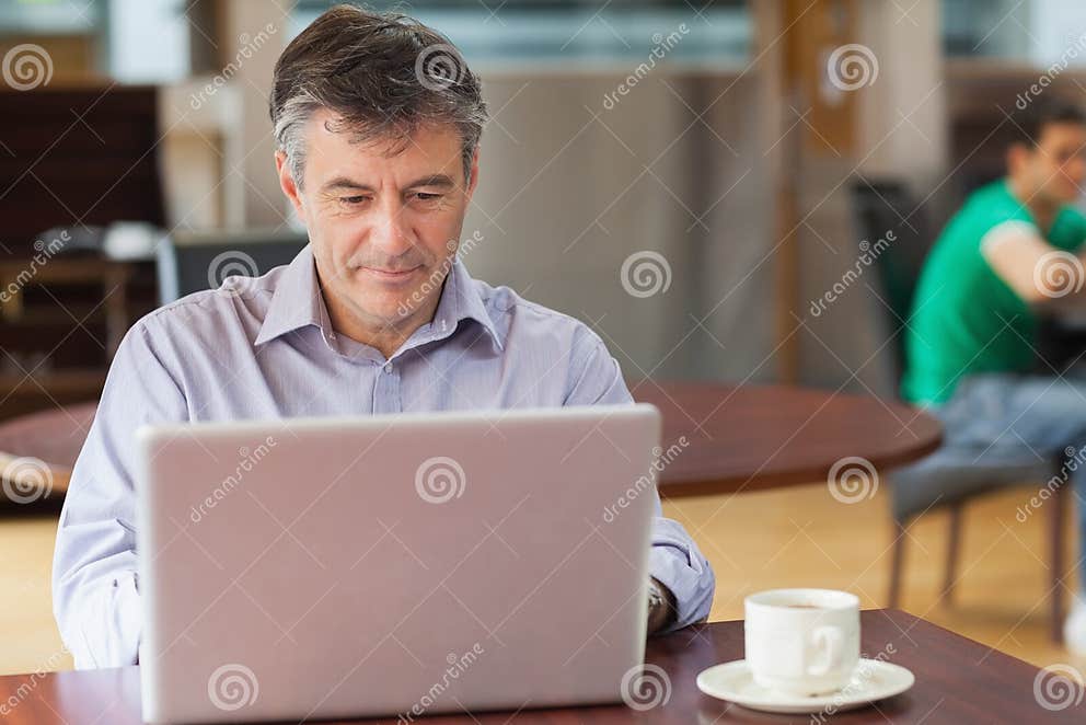 Man in a Coffee Shop Working on the Laptop Stock Photo - Image of cafe ...