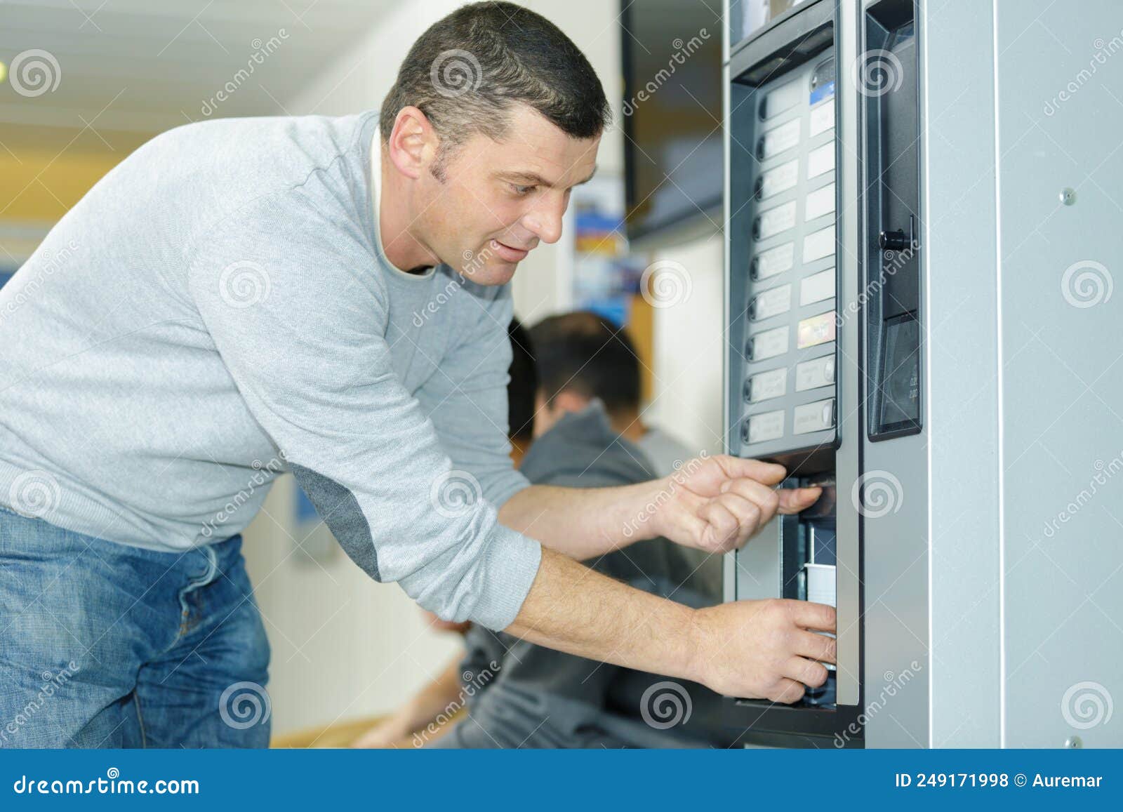 Man in Coffee Vending Machine Stock Photo - Image of money, steel ...