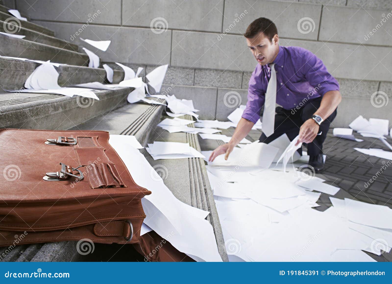 Man Collecting Spilled Paperwork from Steps Stock Image - Image of ...