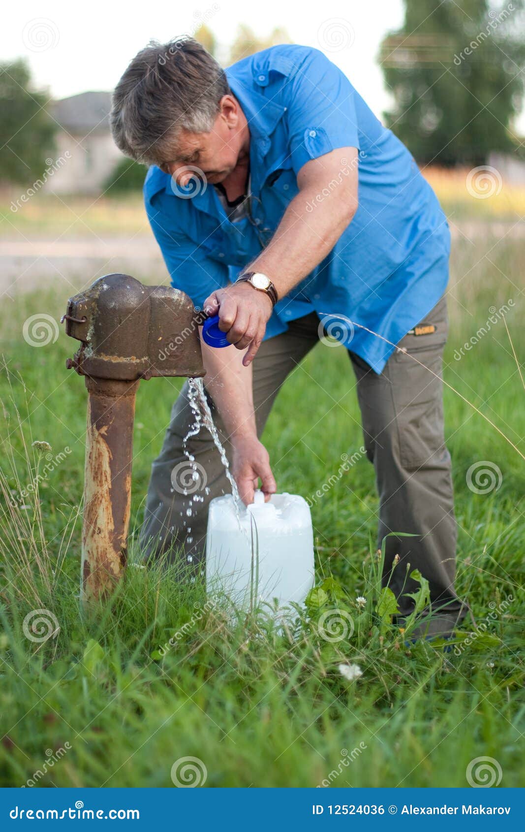 A Man Collects the Water from Stock Photo - Image of rural, green: 12524036