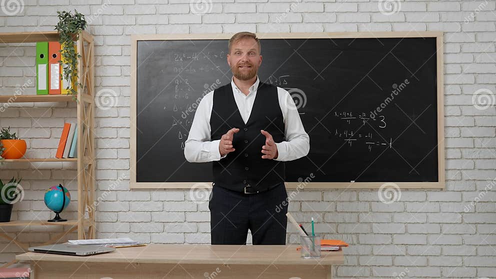Man College Teacher in Classroom in Front of Chalkboard Explaining ...