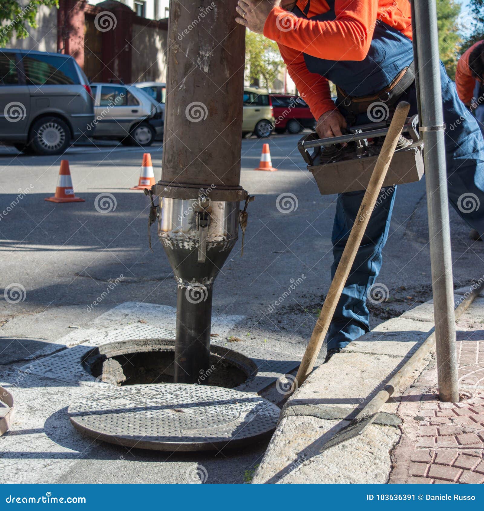 A Man is Commanding a Machine for Cleaning the Manholes in the S Stock ...