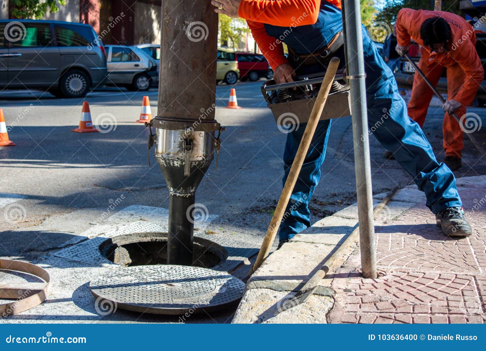 A Man is Commanding a Machine for Cleaning the Manholes in the S Stock ...