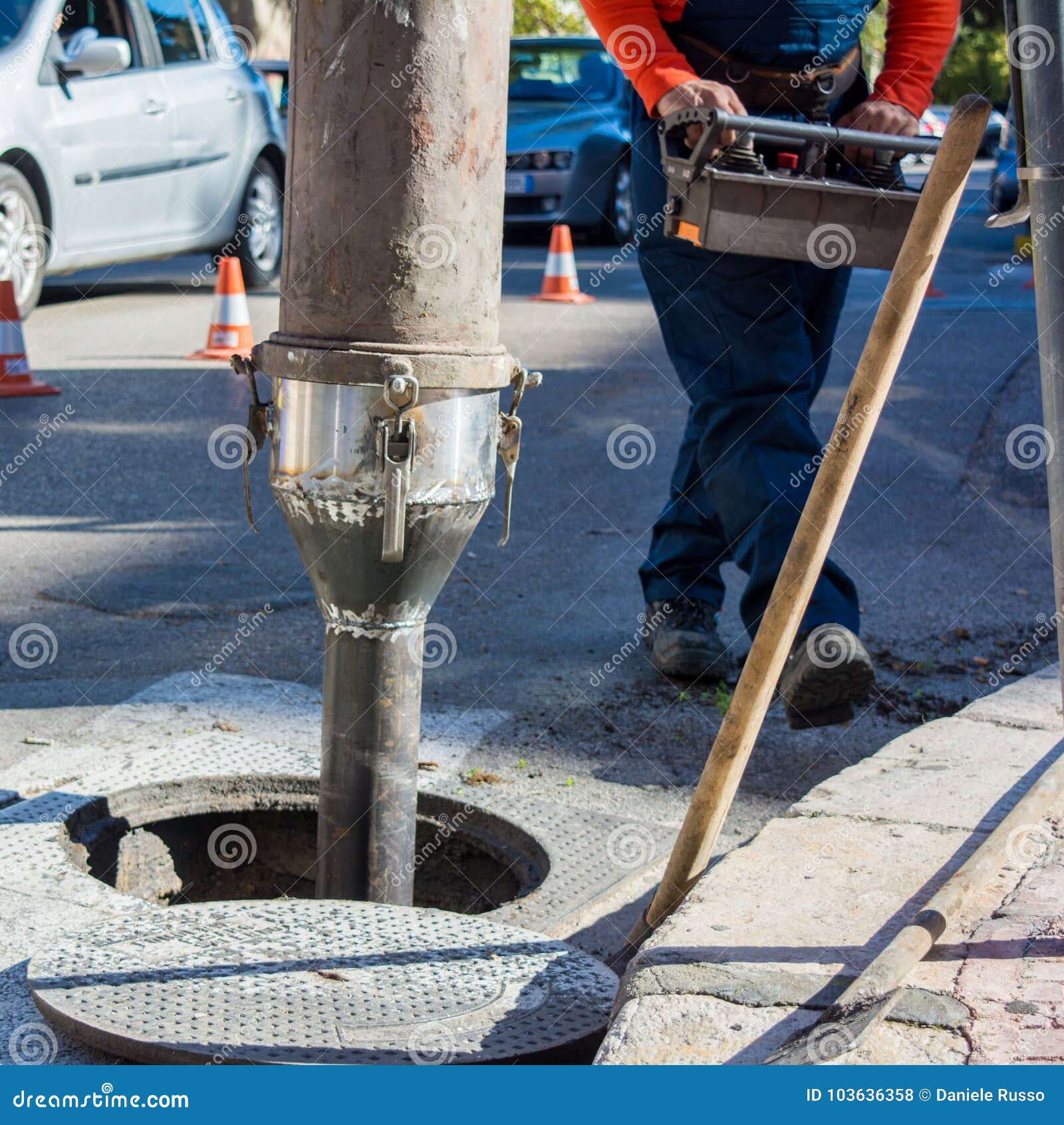 A Man is Commanding a Machine for Cleaning the Manholes in the S Stock ...