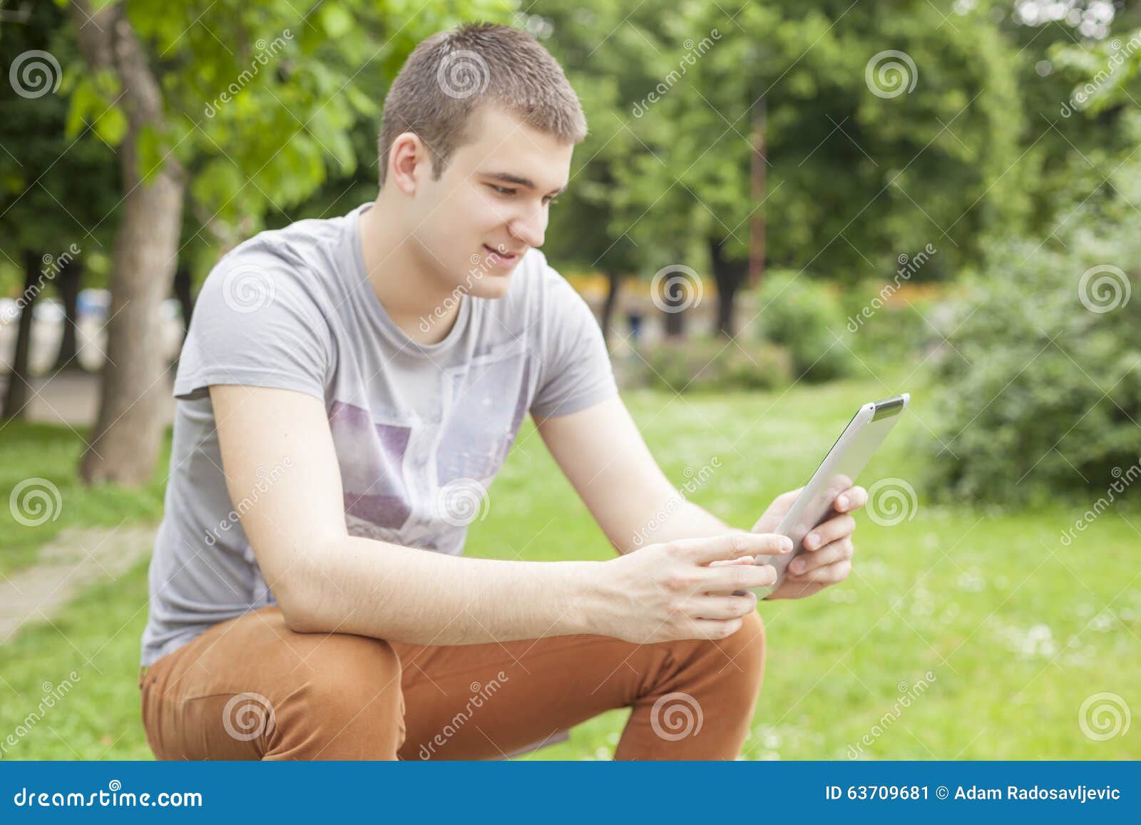 Man Communicate on Social Networks with Tablet Computer in Park Stock ...