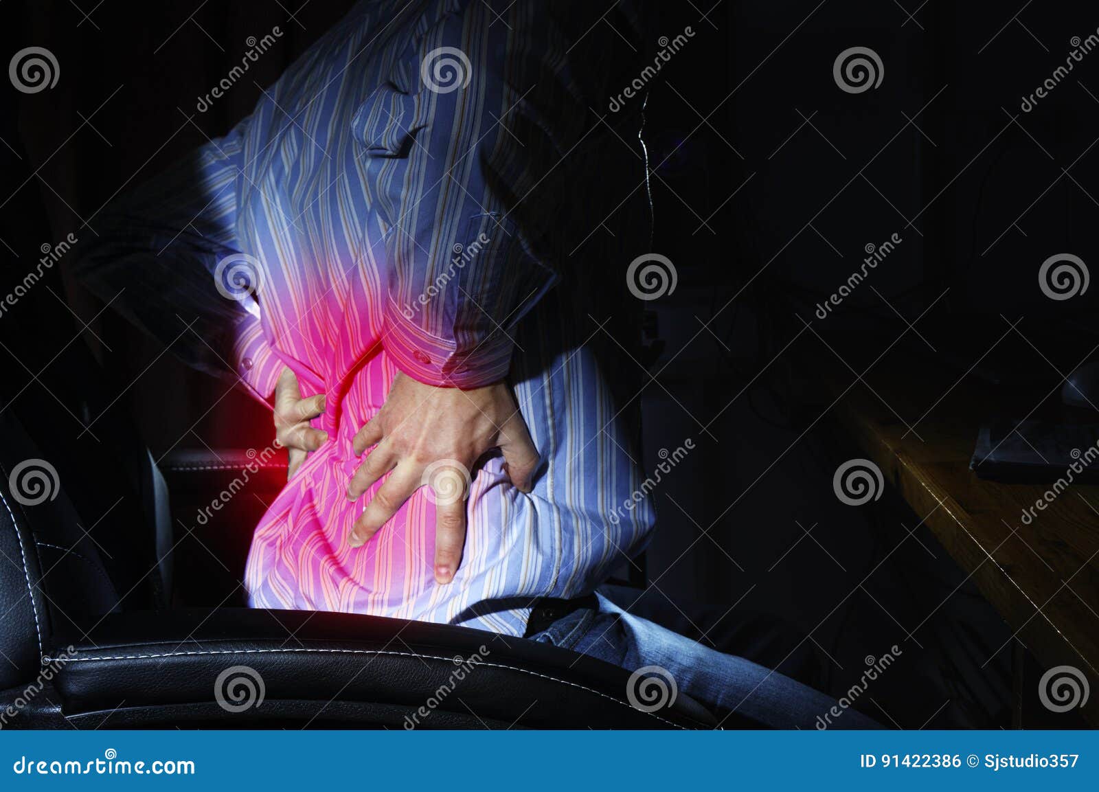 A Man in a Computer Chair at Work, Suffers from Pain in the Back Stock ...