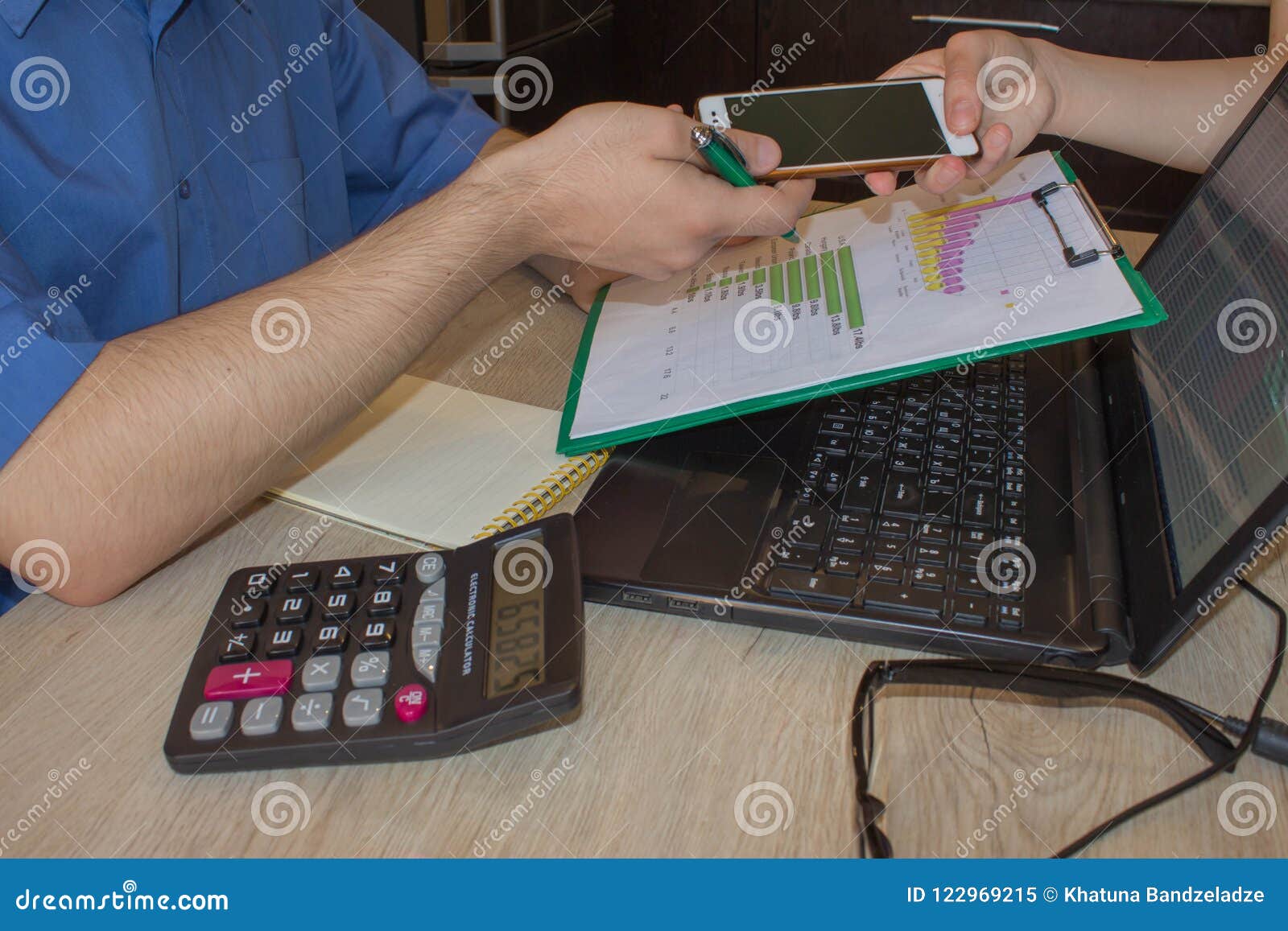 The Man and Computer are Using a Calculator on the Table in the Office ...
