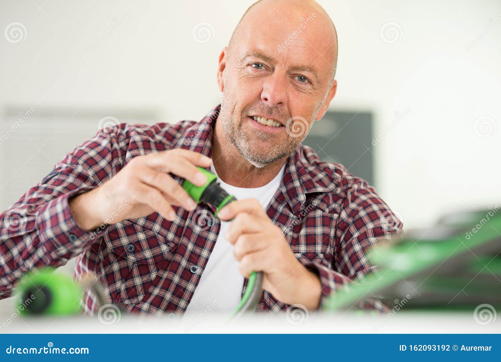 Man connecting hose pipe stock photo. Image of concept - 162093192