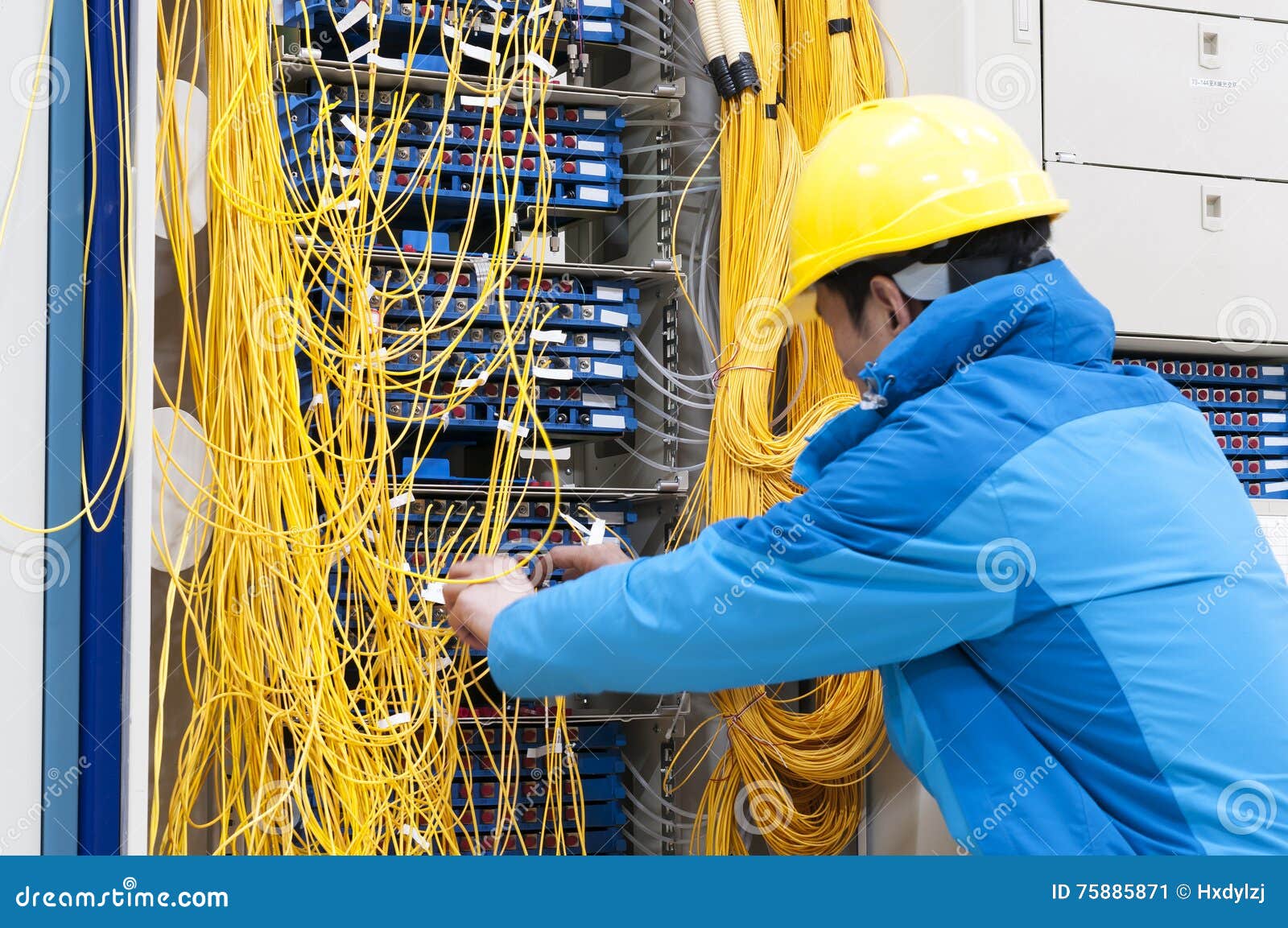 Man Connecting Network Cables To Switches in the Computer Room Stock ...