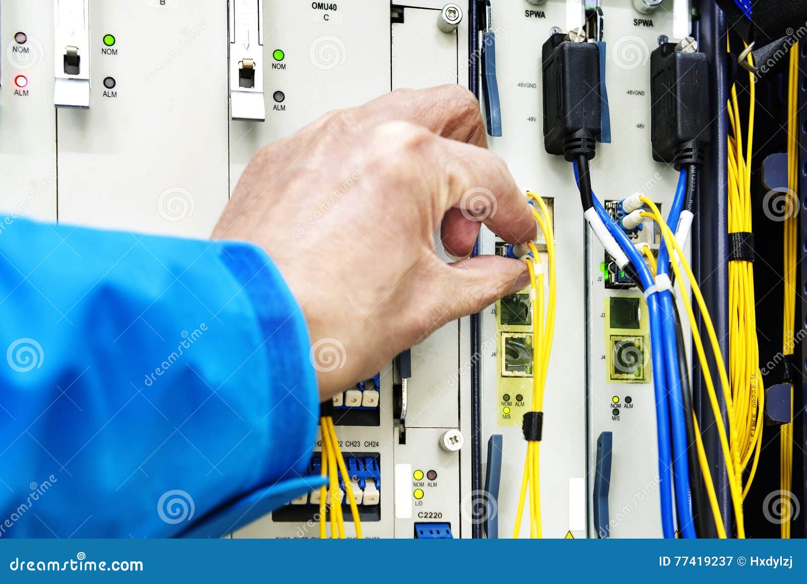 Man Connecting Network Cables To Switches in the Computer Room Stock ...