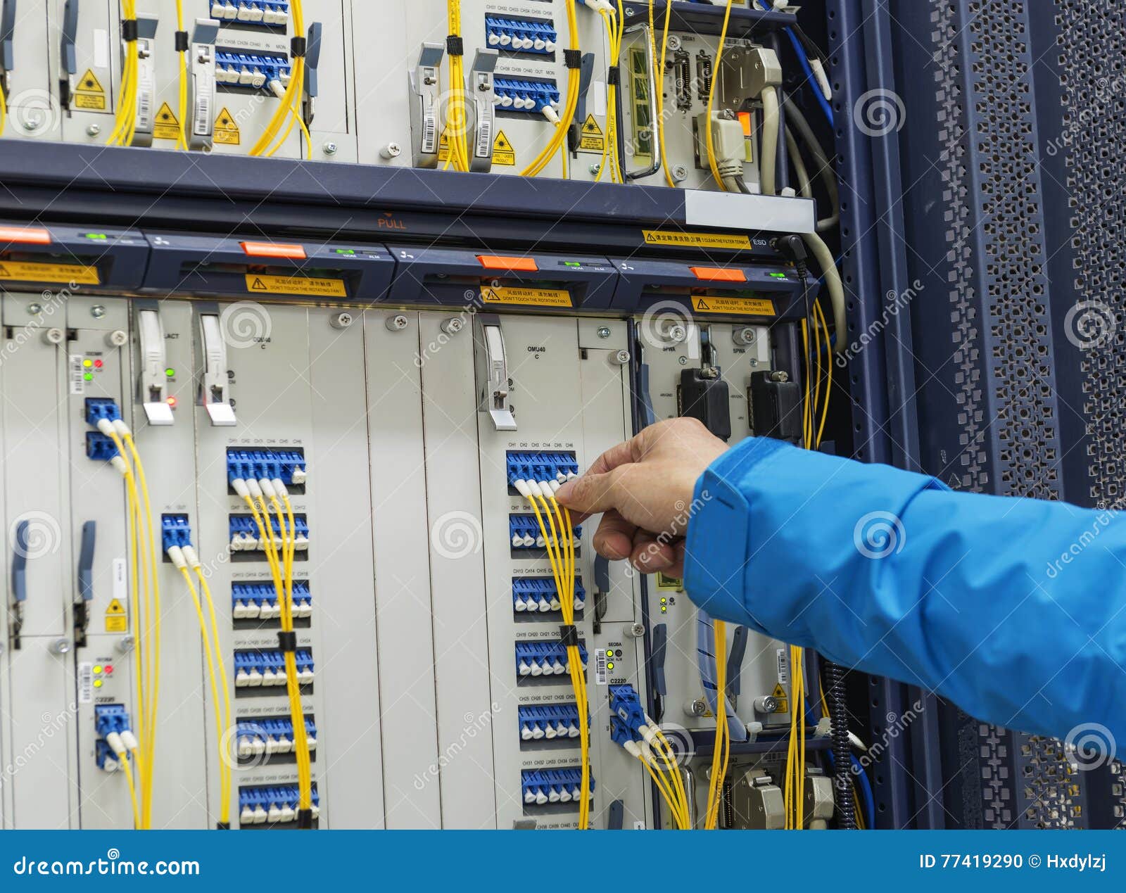 Man Connecting Network Cables To Switches in the Computer Room Stock ...