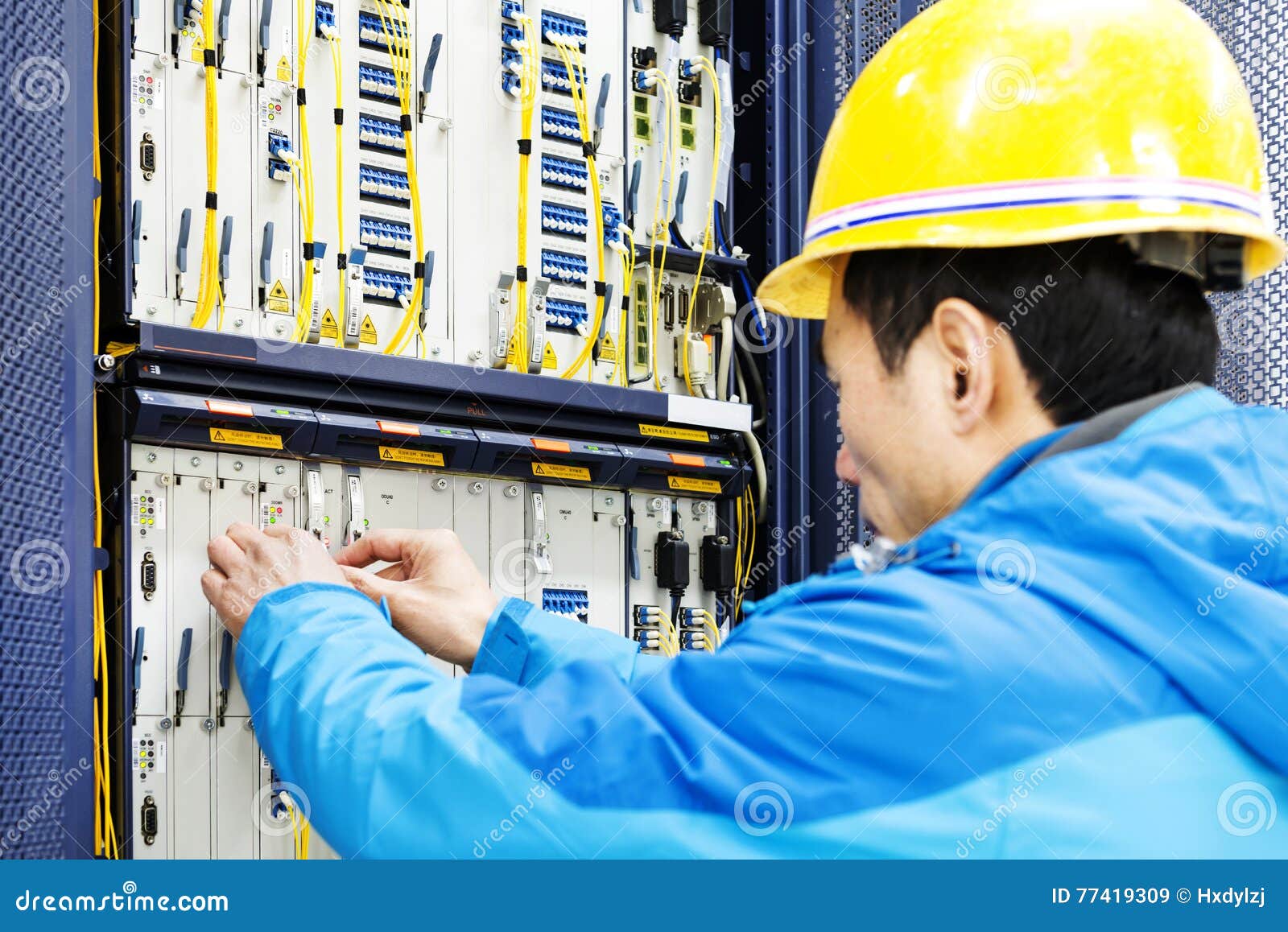Man Connecting Network Cables To Switches in the Computer Room Stock ...