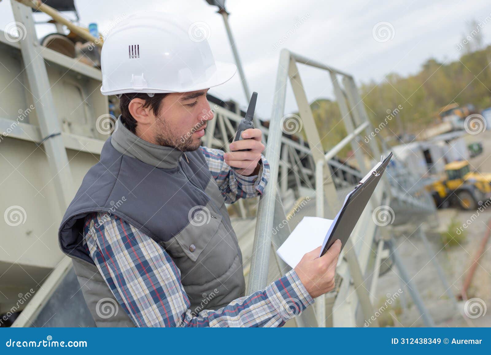 Man on Construction Site Giving Instructions on Walkie Talkie Stock ... Man on Construction Site Giving Instructions on Walkie Talkie Stock ...