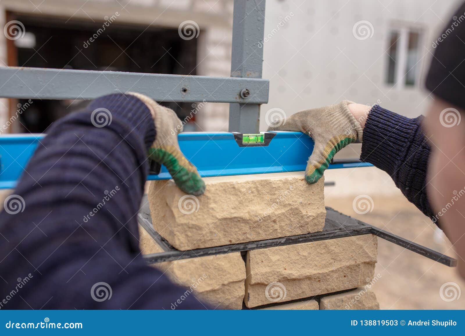 The Man at the Construction Site is Laying Bricks Stock Image - Image ...