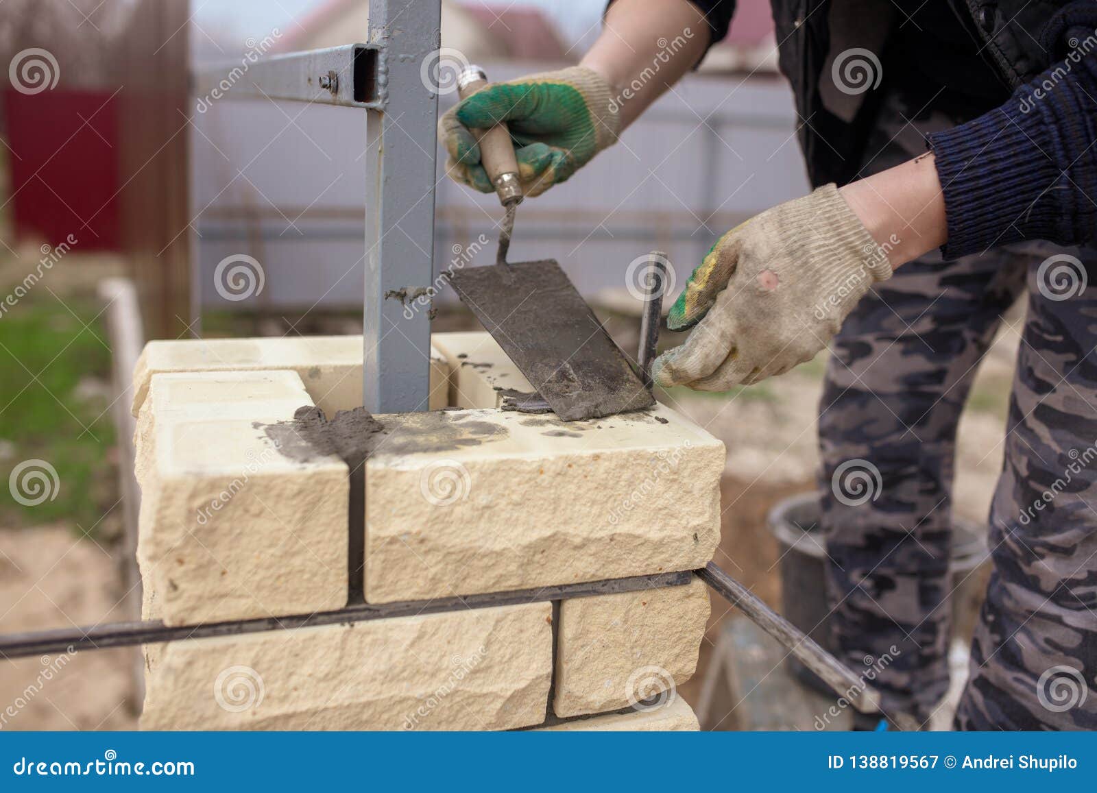 The Man at the Construction Site is Laying Bricks Stock Image - Image ...