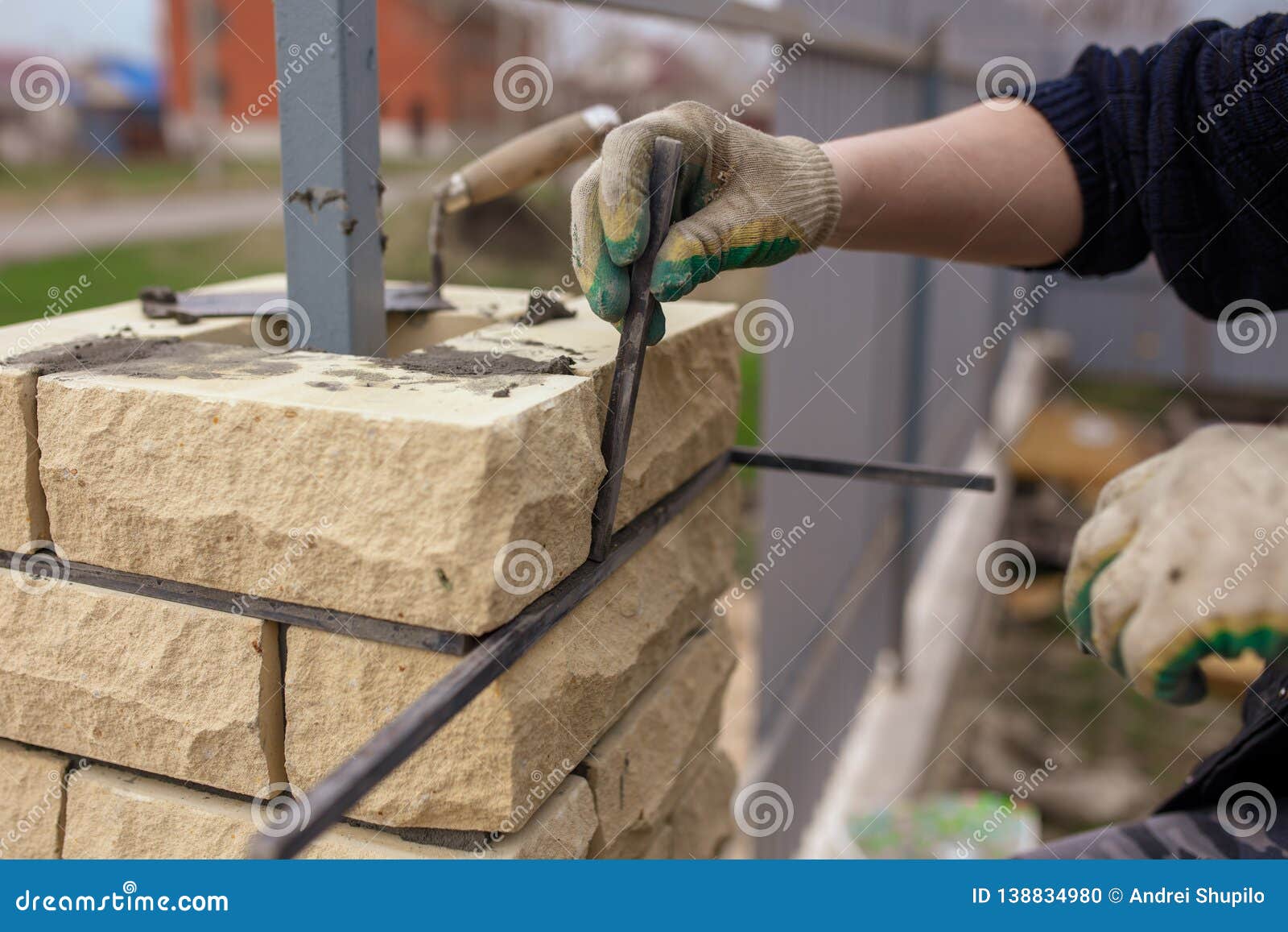 The Man at the Construction Site is Laying Bricks Stock Photo - Image ...