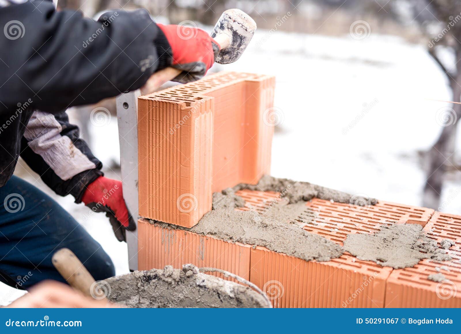 Man on Construction Site Working with Bricks and Mortar, Building House ...