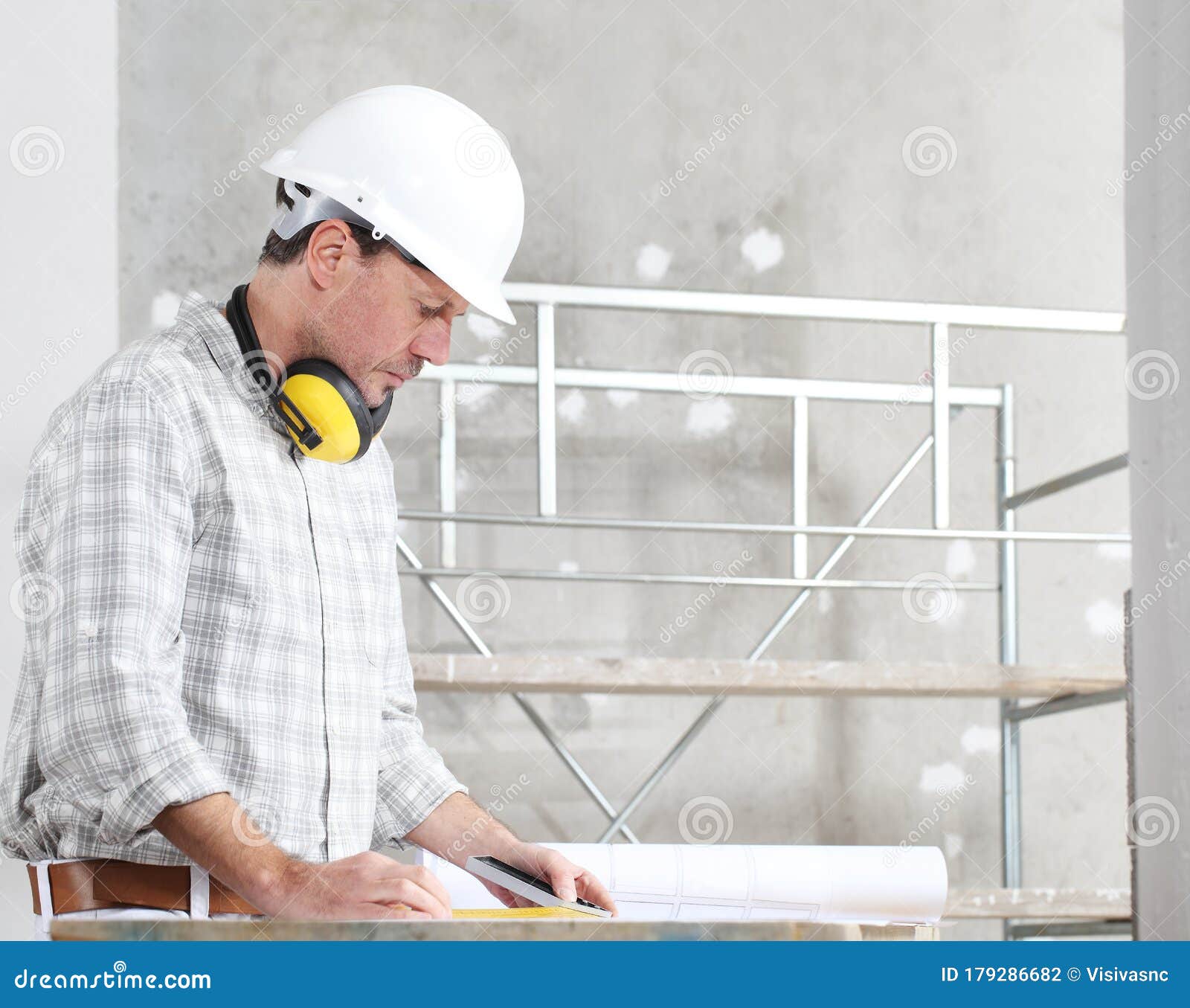 Man Construction Worker Takes the Measures of the Project at Interior ...