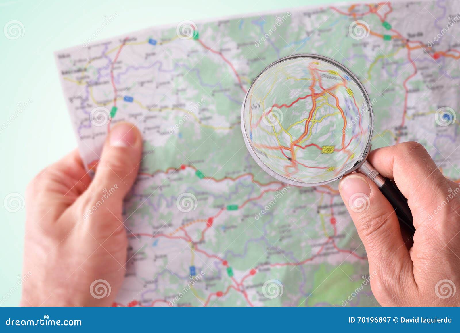 Man Consulting a Map with a Magnifying Glass Stock Image - Image of ...