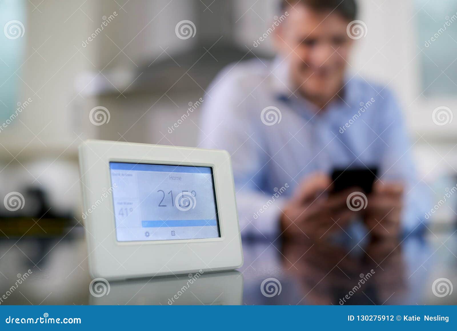 Man Controlling Central Heating Smart Meter Using App on Mobile Stock ...