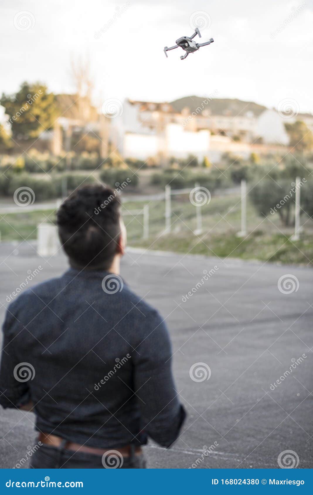 Man Controlling Drone in Outdoors Image with Remote Control and ...
