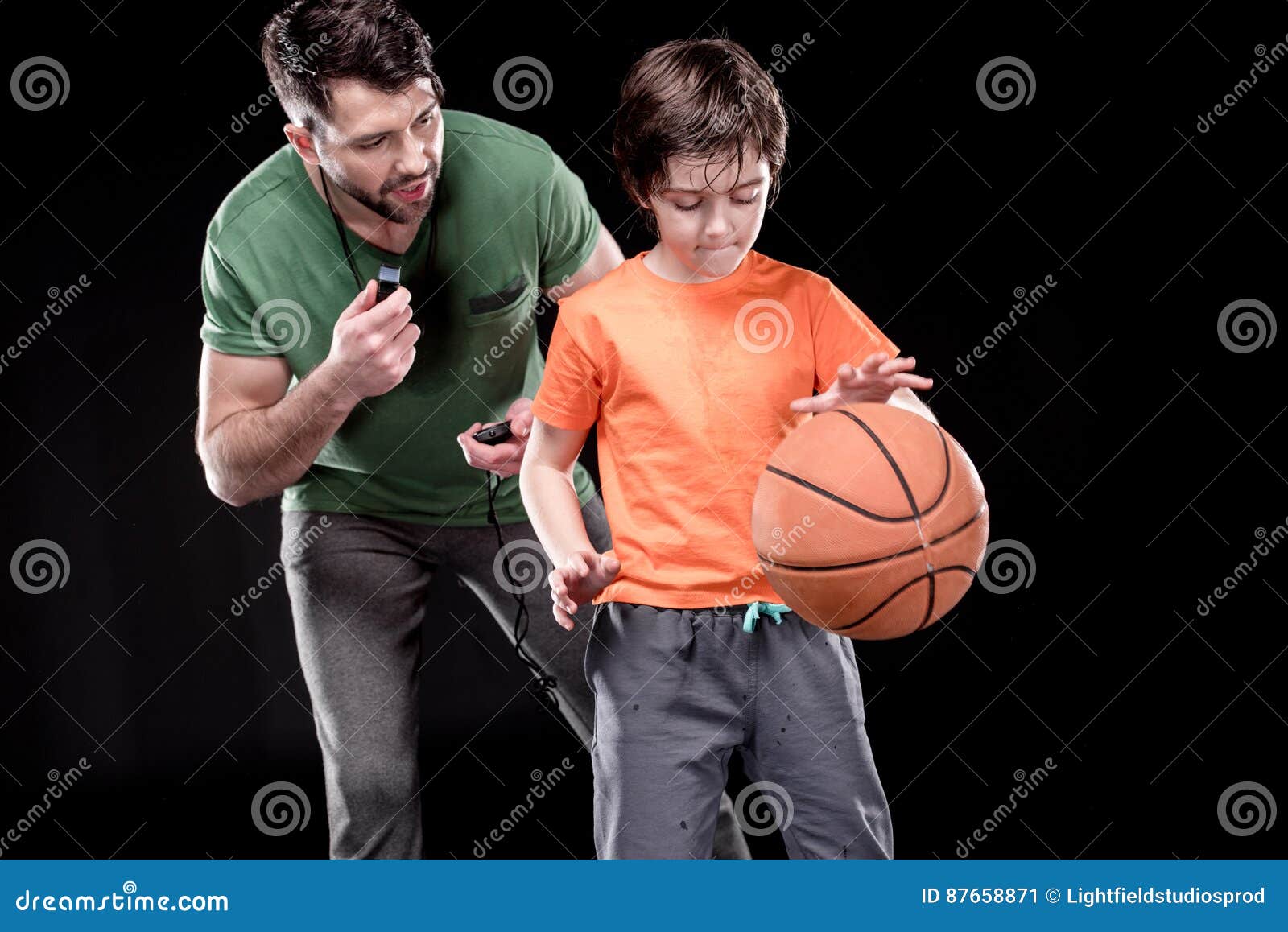 Man Controlling Time while Concentrated Boy Training with Basketball ...