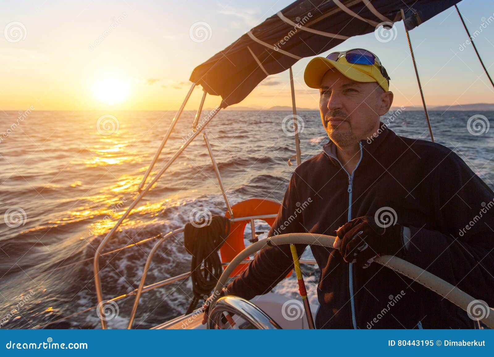 A Man Controls a Sailing Ship at Sunset. Stock Image - Image of cruise ...