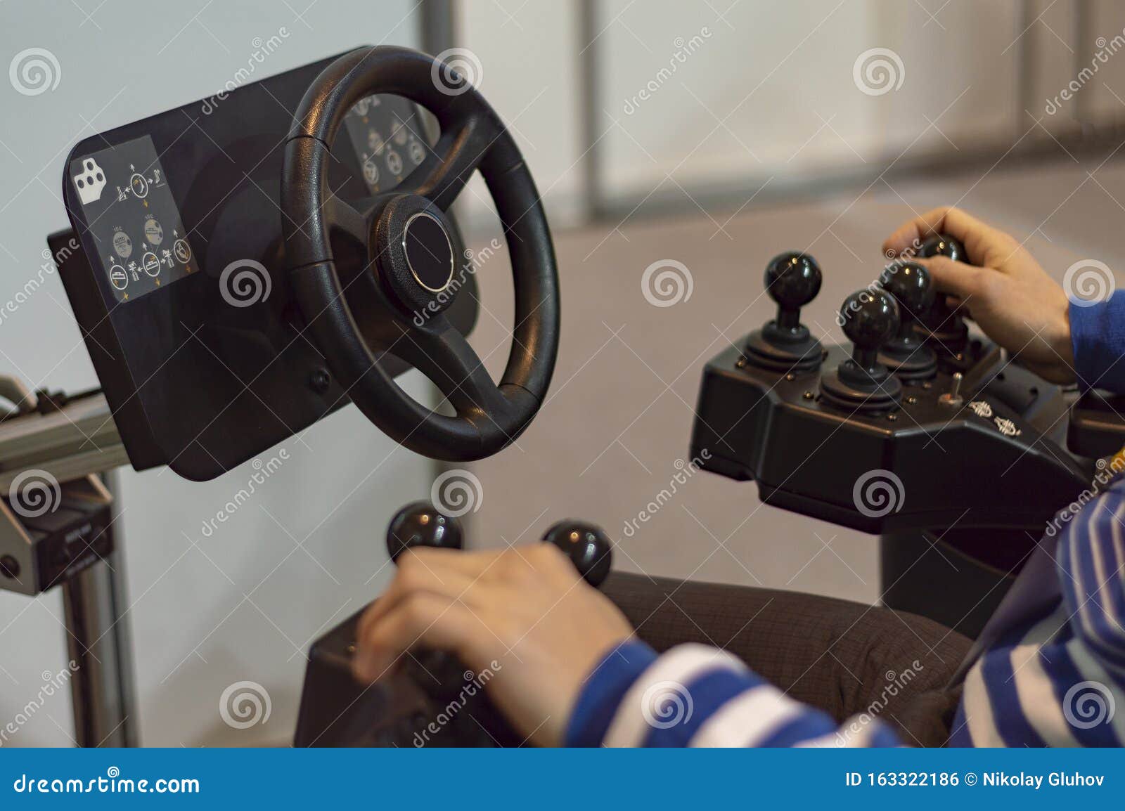 A Man Controls Tractor Simulator - an Excavator. Stock Photo - Image of ...