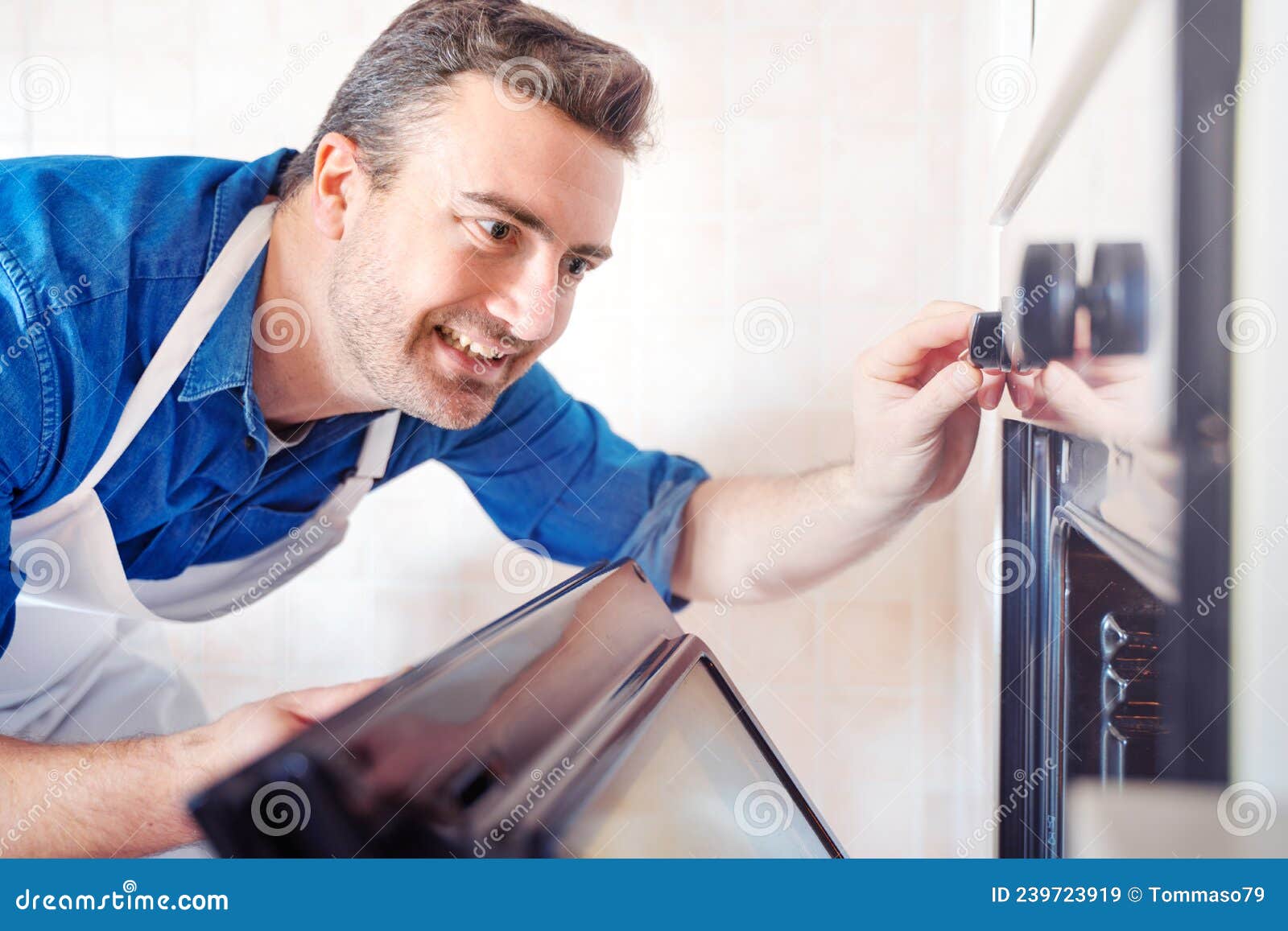 Man Cooking and Baking a Cake Looking in the Oven Stock Image - Image ...