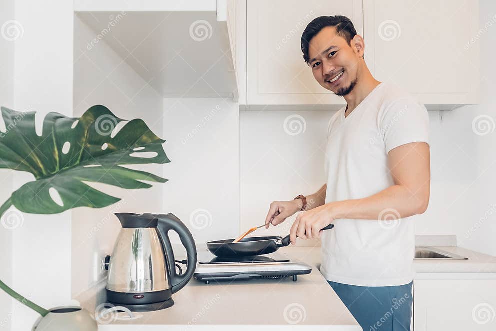 Man is Cooking Breakfast in the Kitchen. Stock Image - Image of happy ...