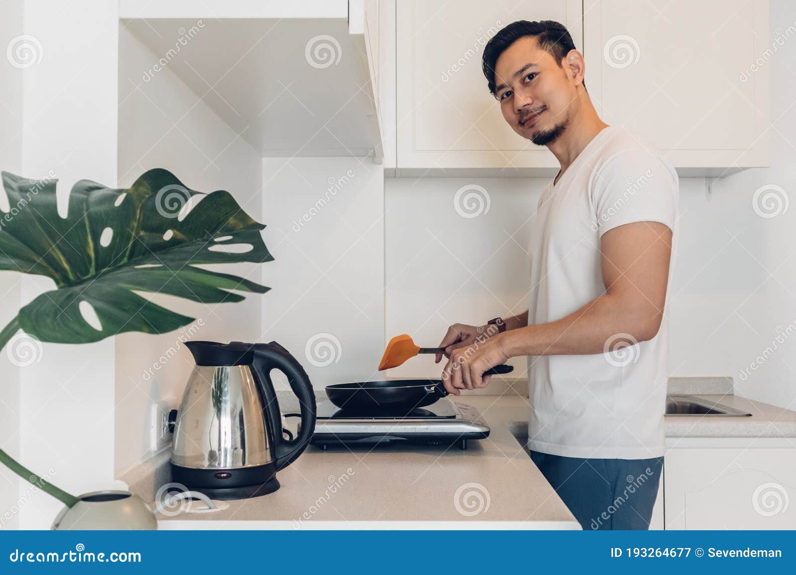 Man is Cooking Breakfast in the Kitchen. Stock Image - Image of ...