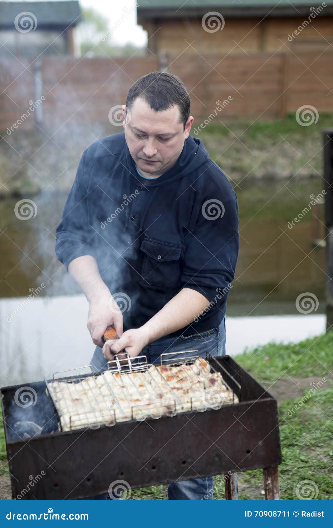 Man cooking chicken stock image. Image of backyard, grilling - 70908711