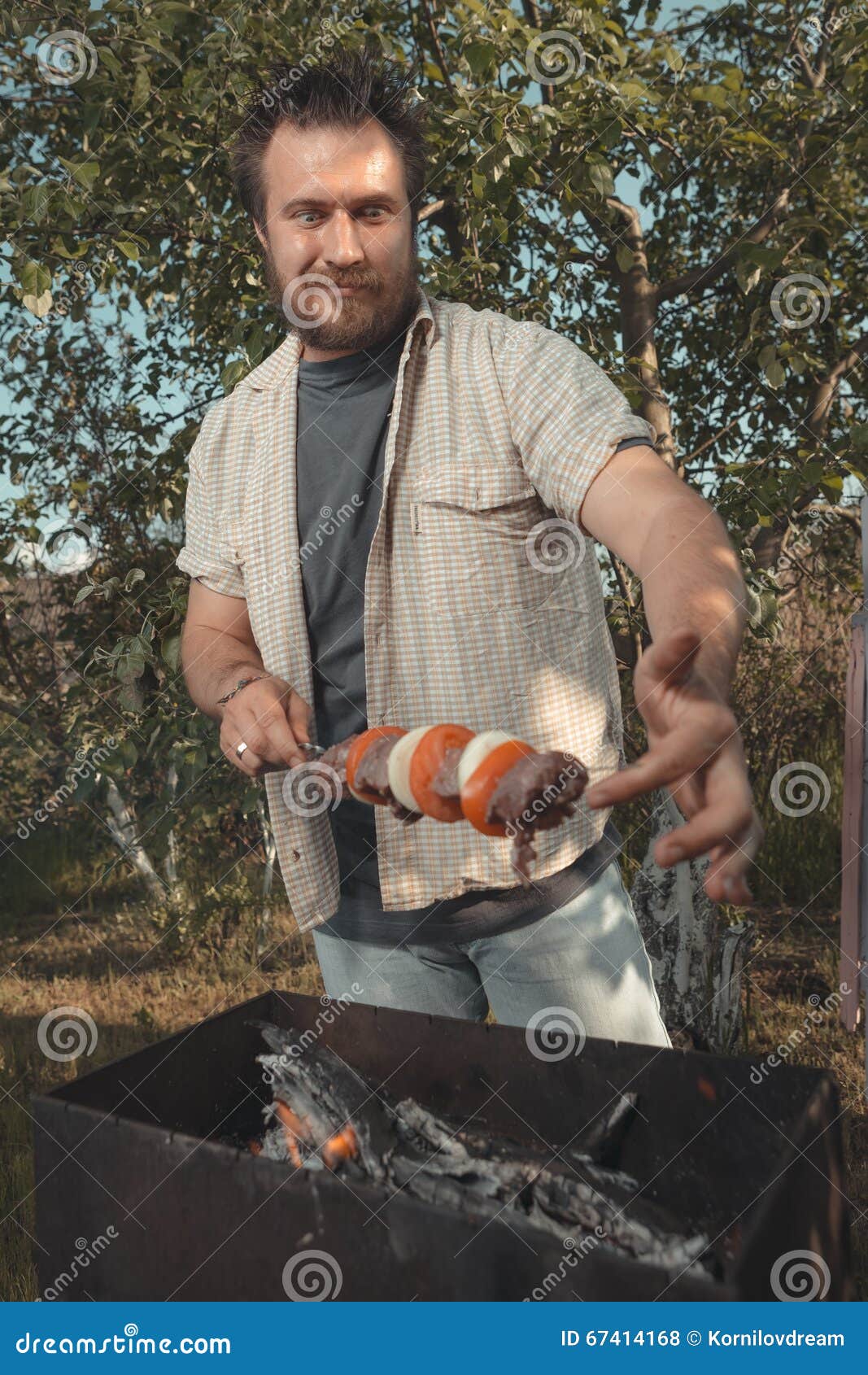 Man cooking on grill stock photo. Image of countryside - 67414168