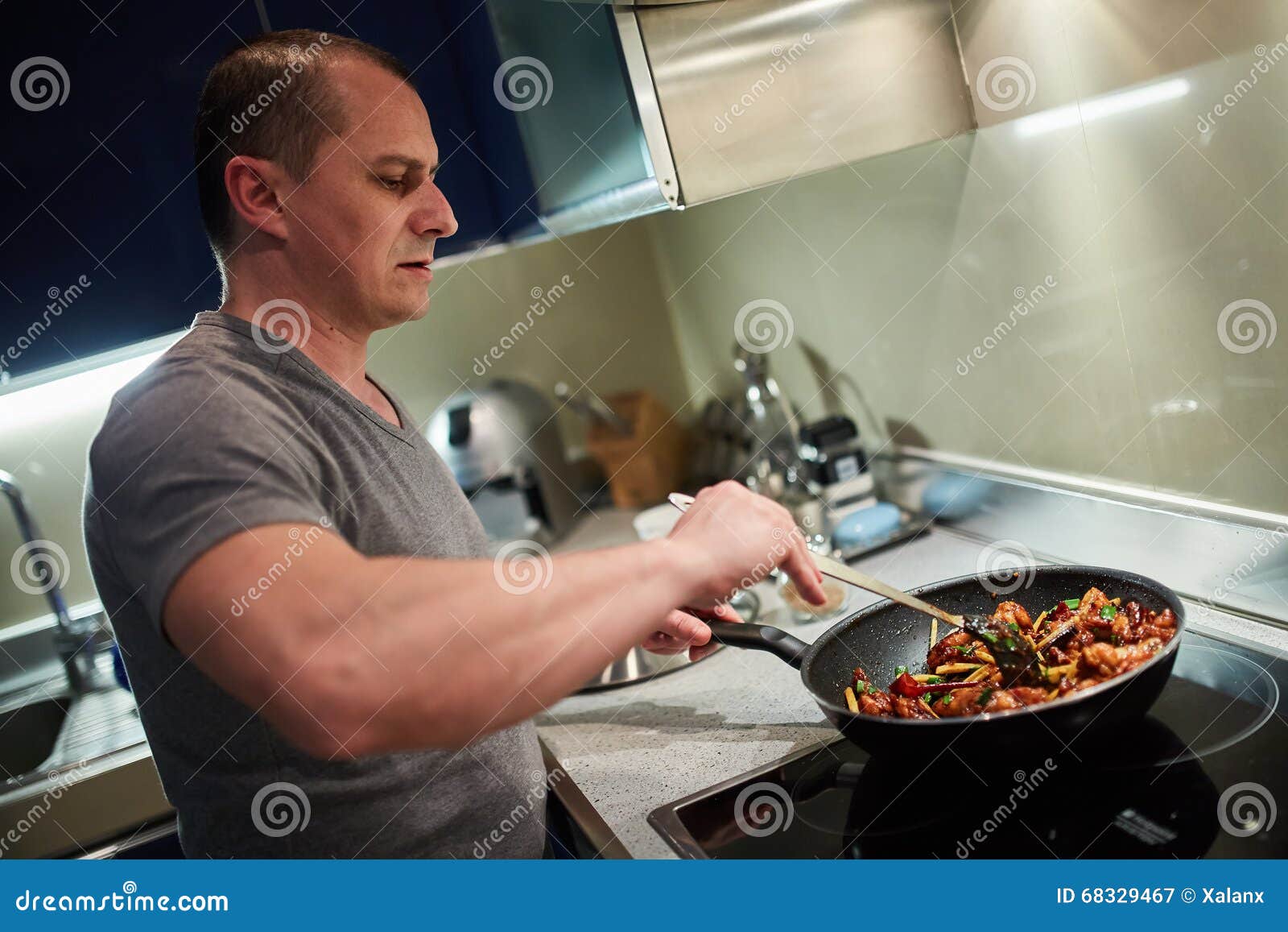 Man cooking at home alone stock image. Image of apartment - 68329467