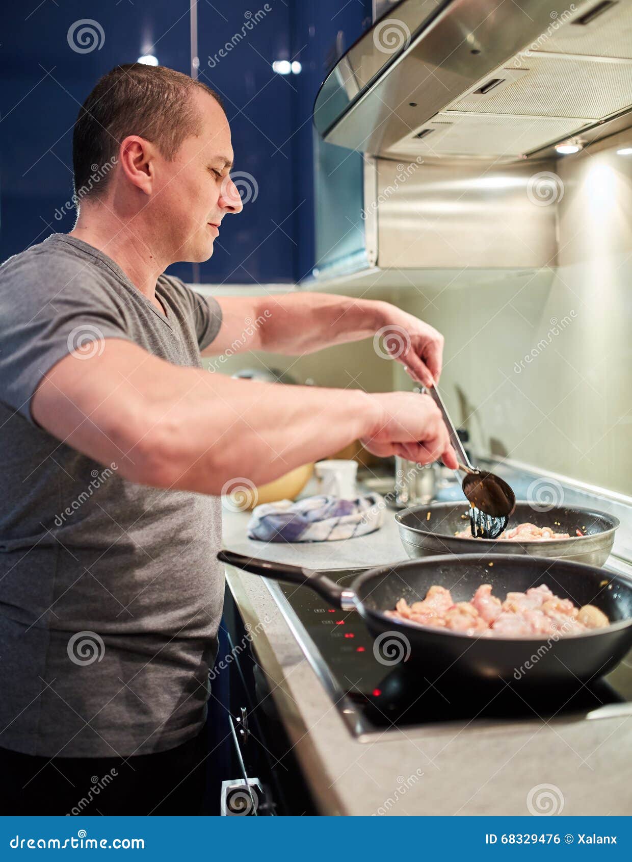 Man cooking at home alone stock photo. Image of happy - 68329476
