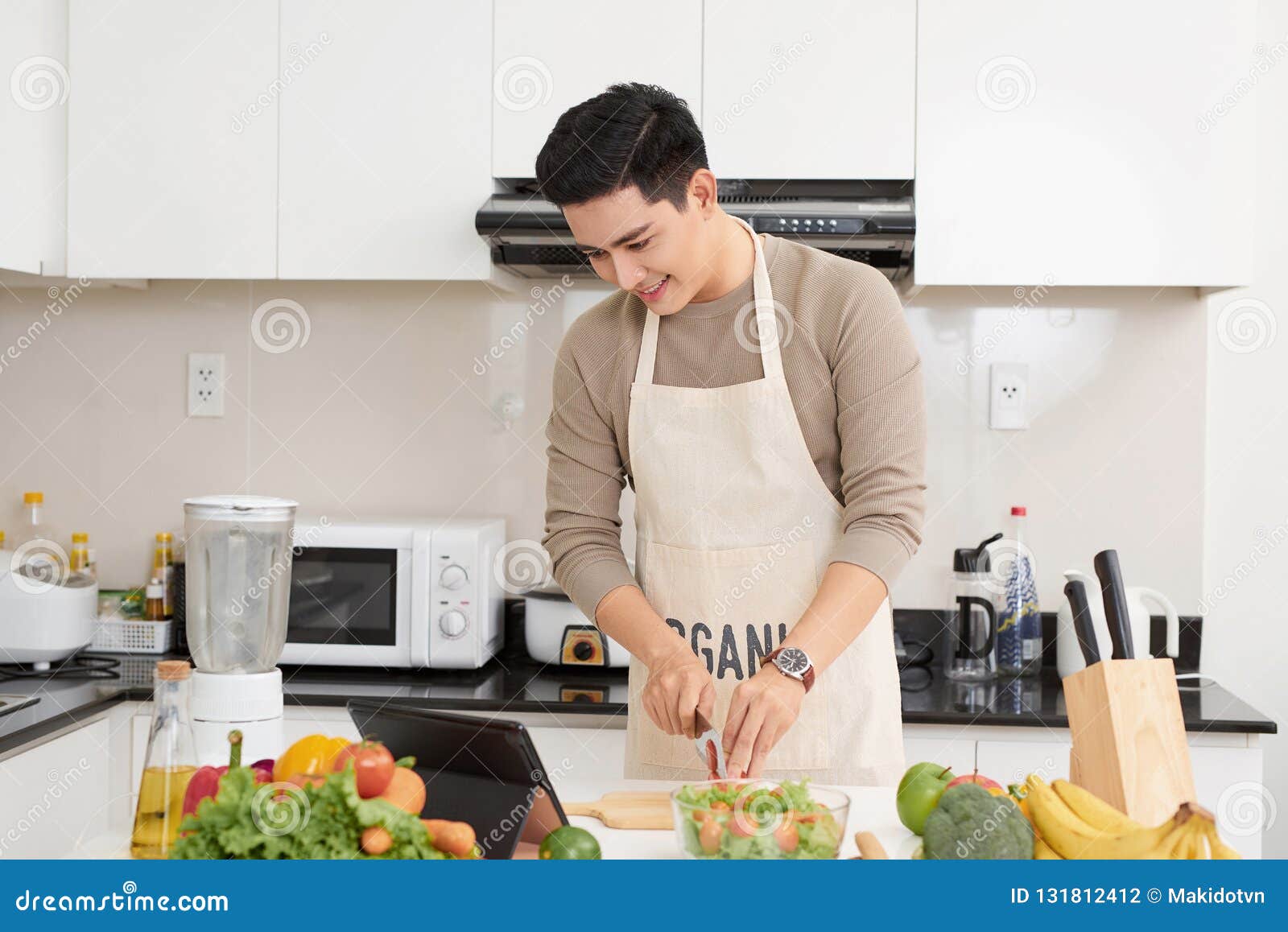 Man Cooking at Home in Kitchen, Using Tablet Computer Stock Photo ...