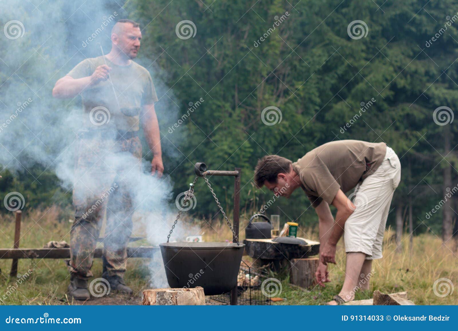 Man Cooking Meat Over Bonfire at Campsite Editorial Stock Photo - Image ...