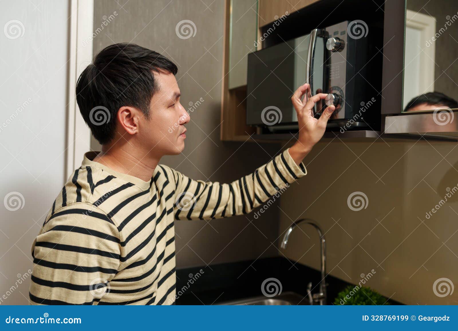 Man Cooking with a Microwave in Kitchen Room Stock Image - Image of ...