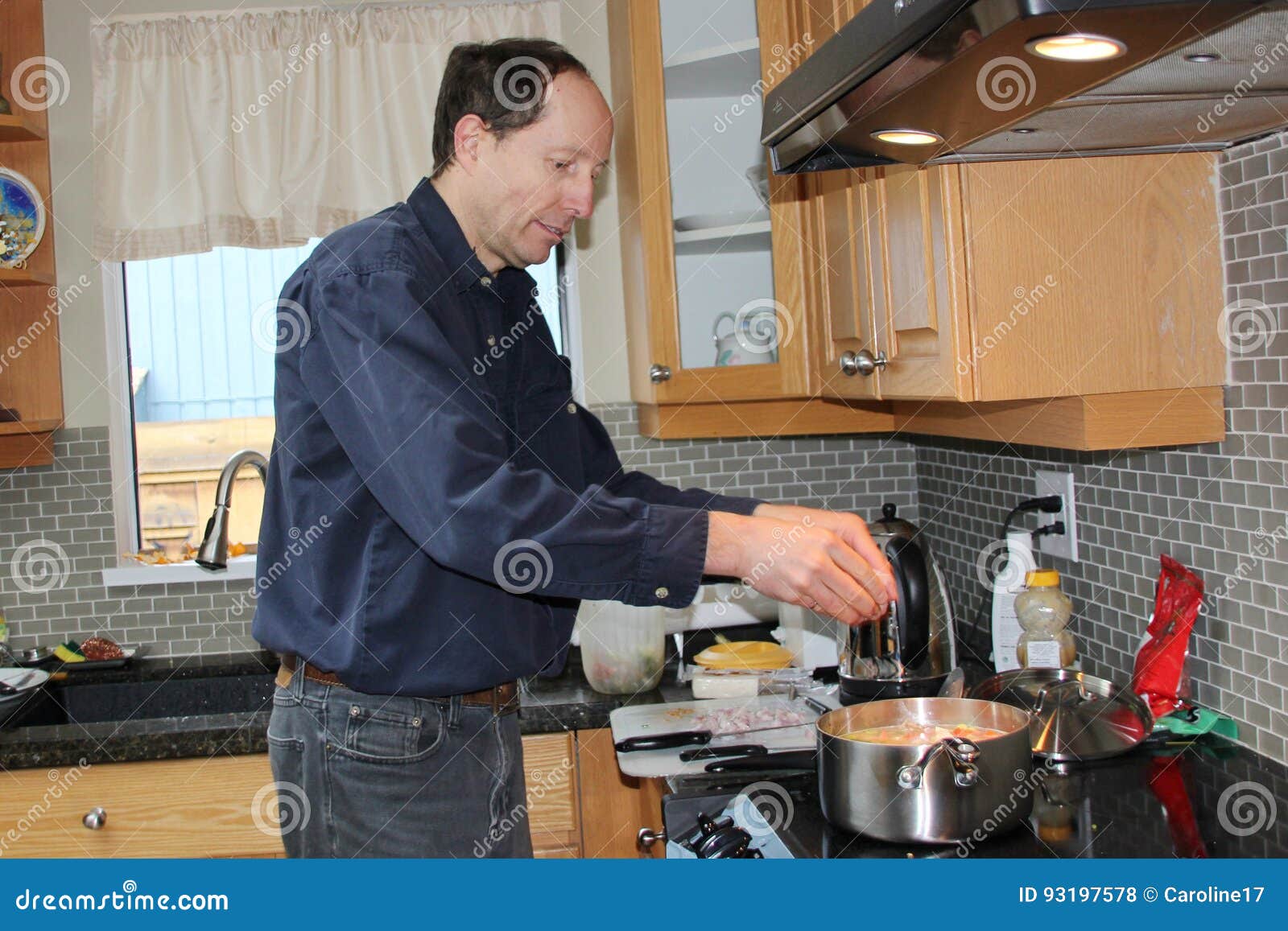 Man Cooking over his Stove stock photo. Image of blue - 93197578