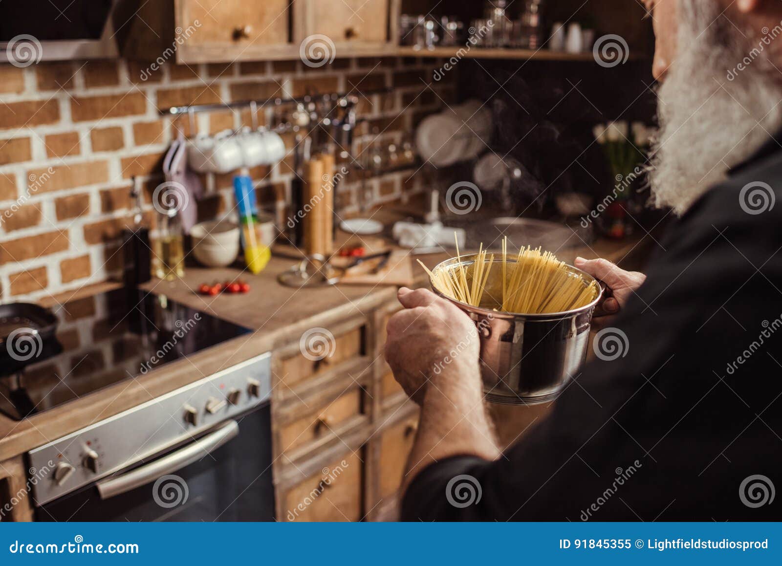 Man cooking spaghetti stock image. Image of elderly, kitchen - 91845355