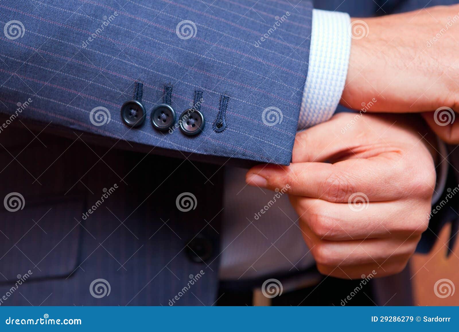 Man correcting a sleeve stock image. Image of checking - 29286279