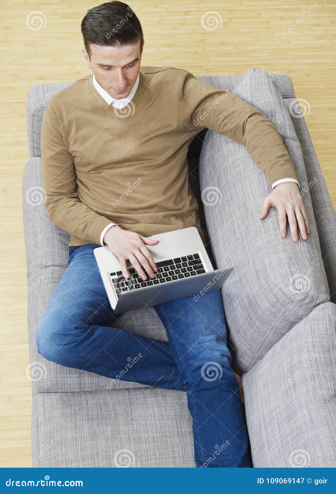 Man on couch with laptop stock image. Image of employment - 109069147