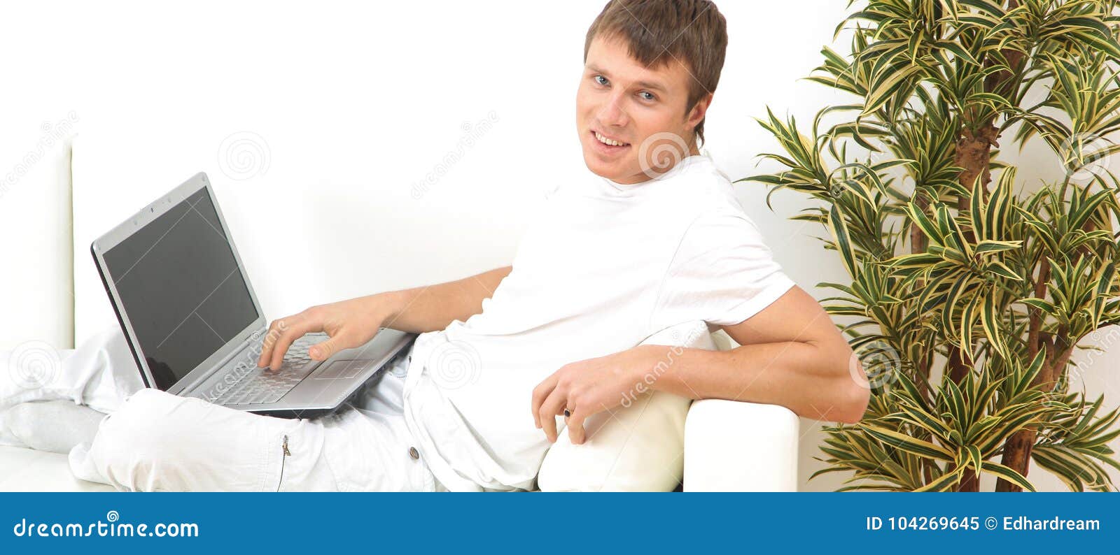 Very Focused Young Man Using Laptop while Sitting Comfortably. Stock ...