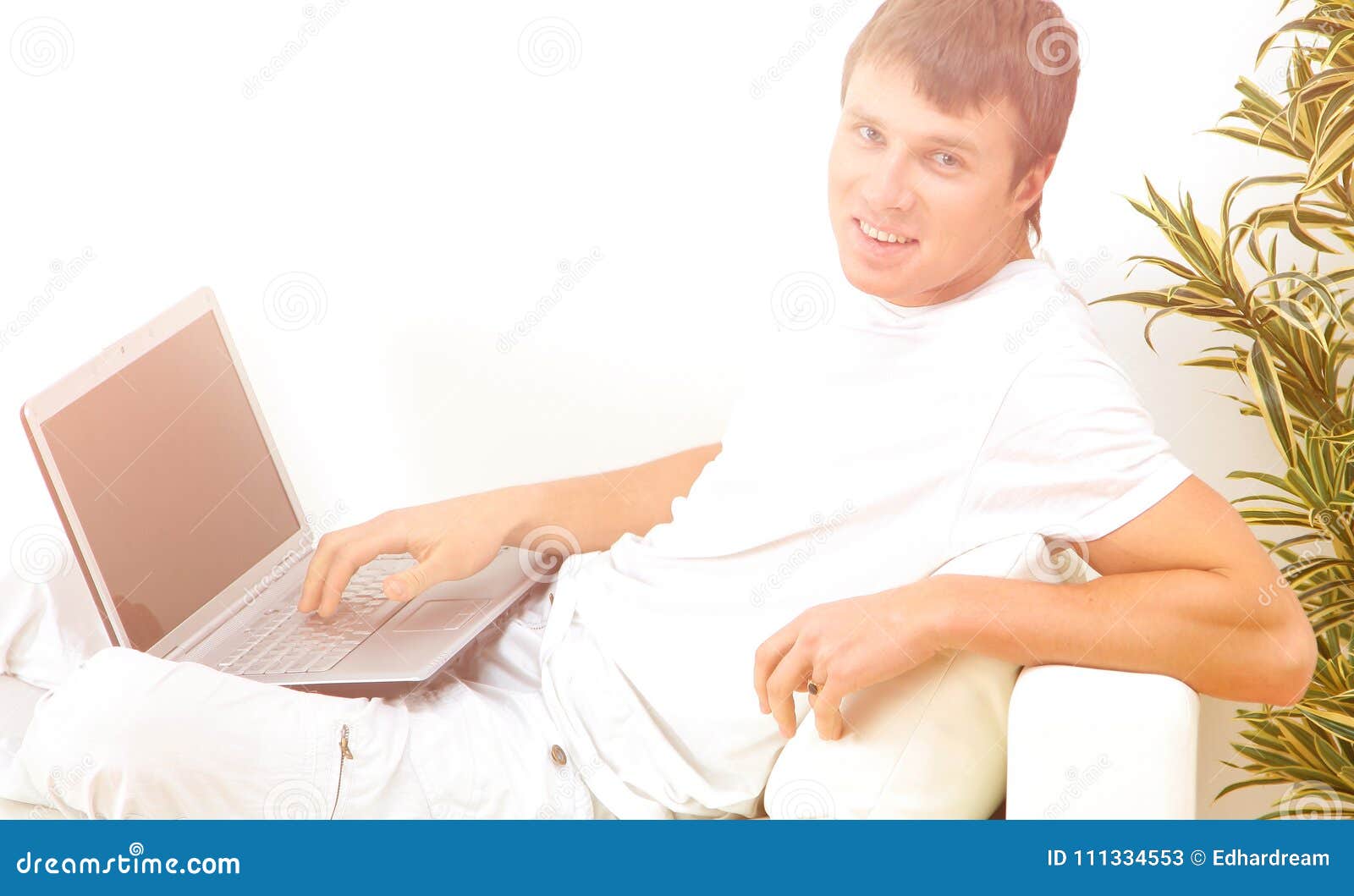 Very Focused Young Man Using Laptop while Sitting Comfortably. Stock ...