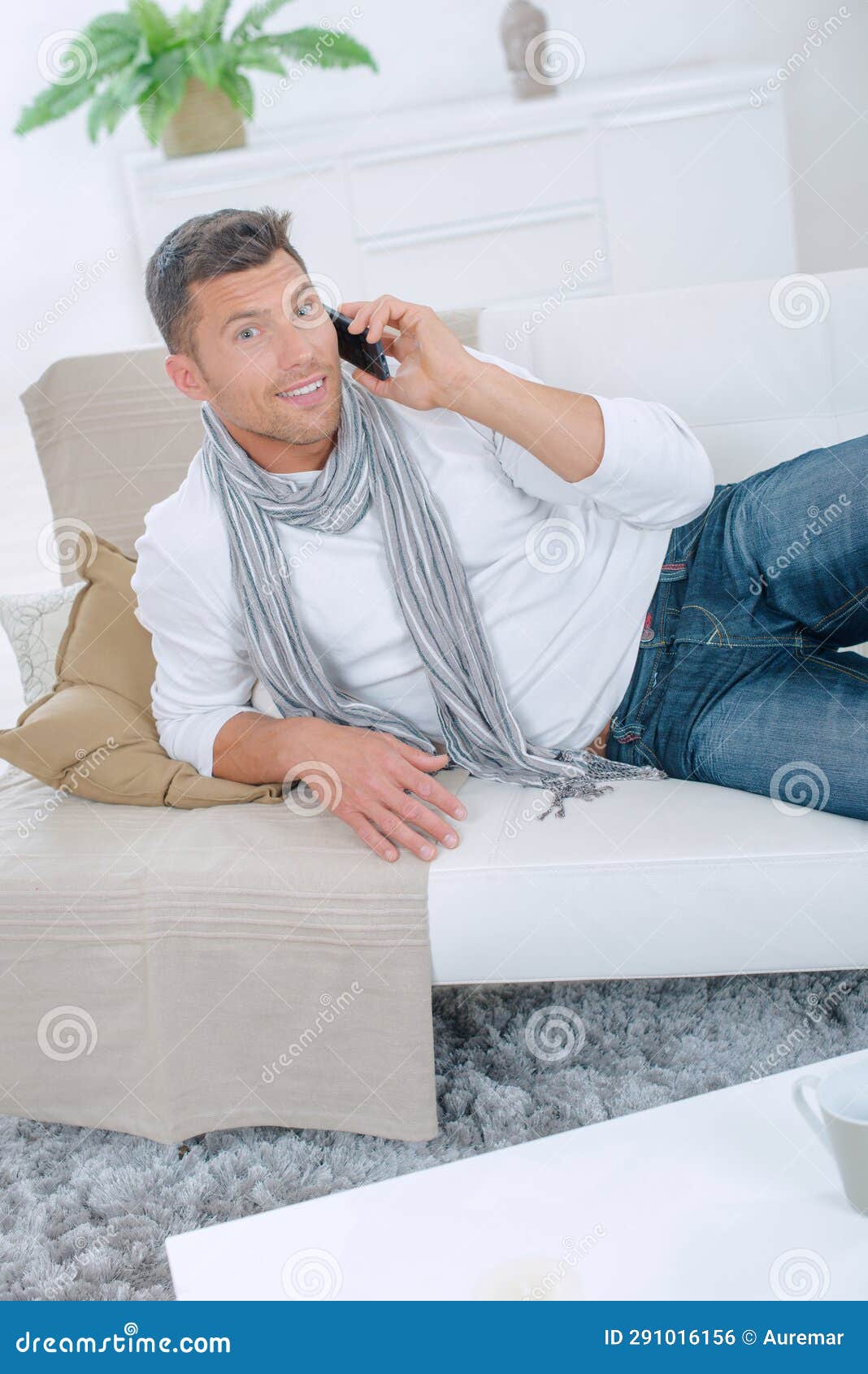 Man on Couch on Telephone Surprised Expression Stock Photo - Image of ...