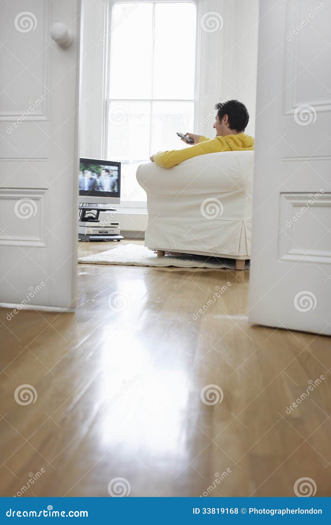 Man on Couch and Watching TV Stock Photo - Image of relaxation, relaxed ...