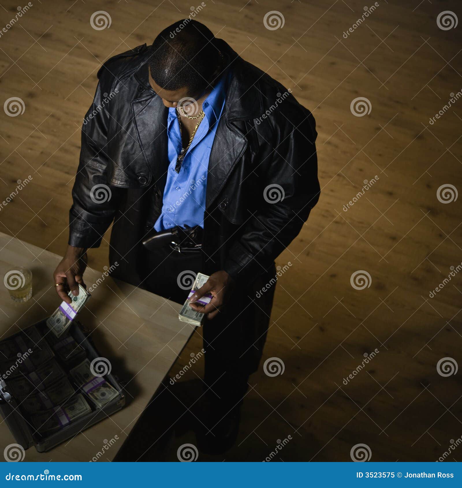 Man counting money at desk stock image. Image of dark - 3523575