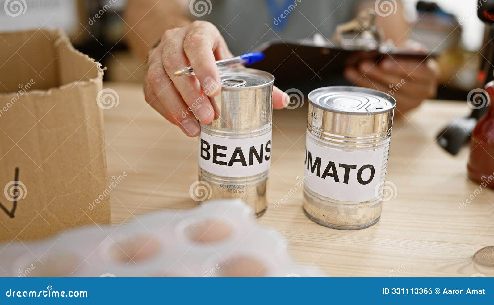 Man Counts Donations in Warehouse, Focusing on Cans Labeled Beans and ...