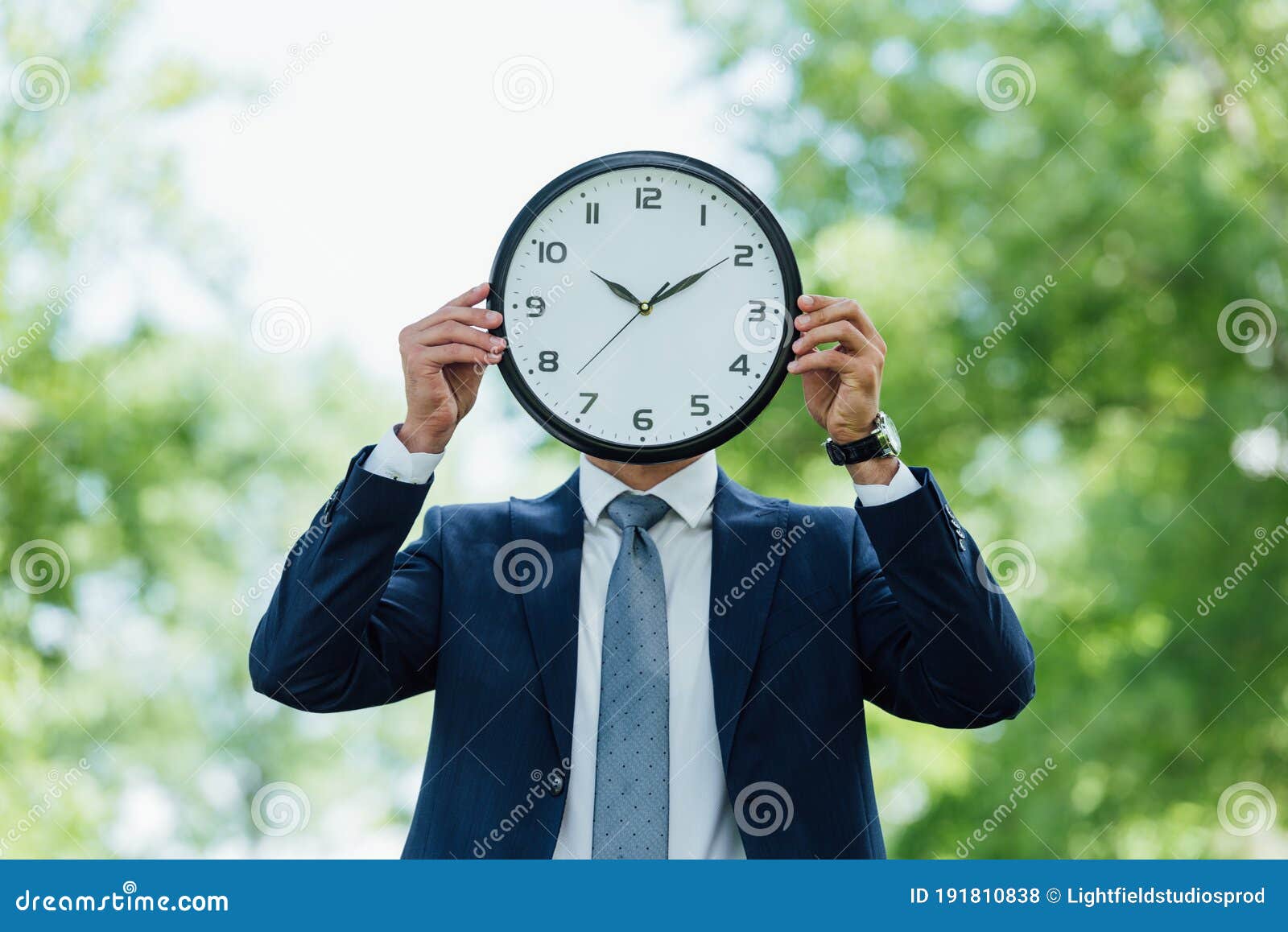 Man Covering Face with Clock while Standing in Park Stock Photo - Image ...