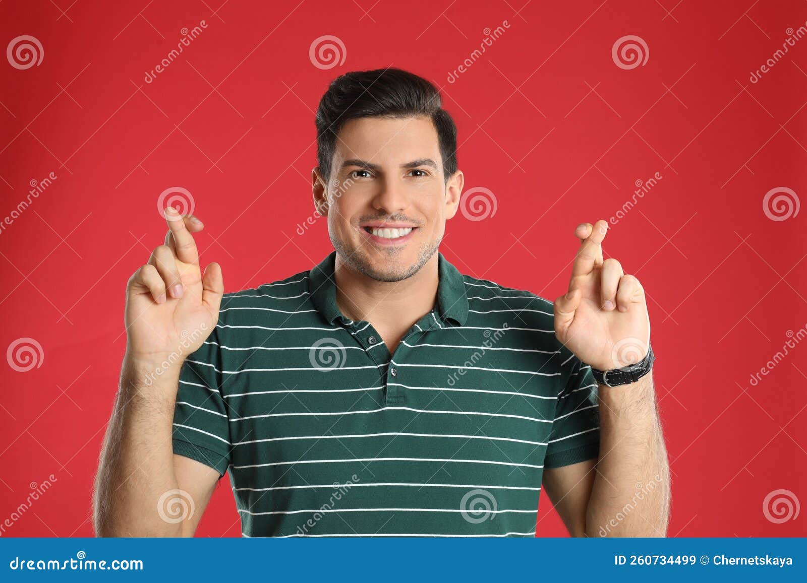 Man with Crossed Fingers on Red Background. Superstition Concept Stock ...